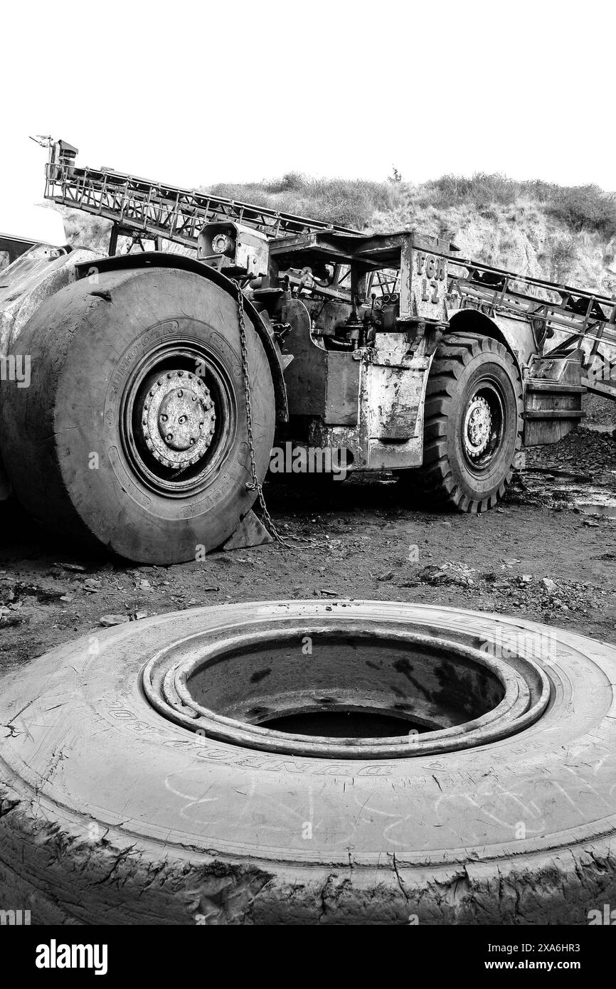 A grayscale image of a tractor in an industrial factory area in ...