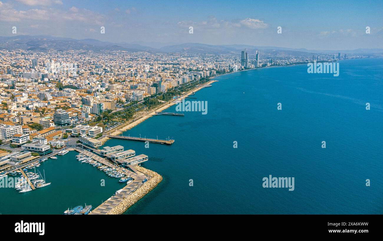 Aerial view of boats docked in a harbor with city buildings and sky in ...