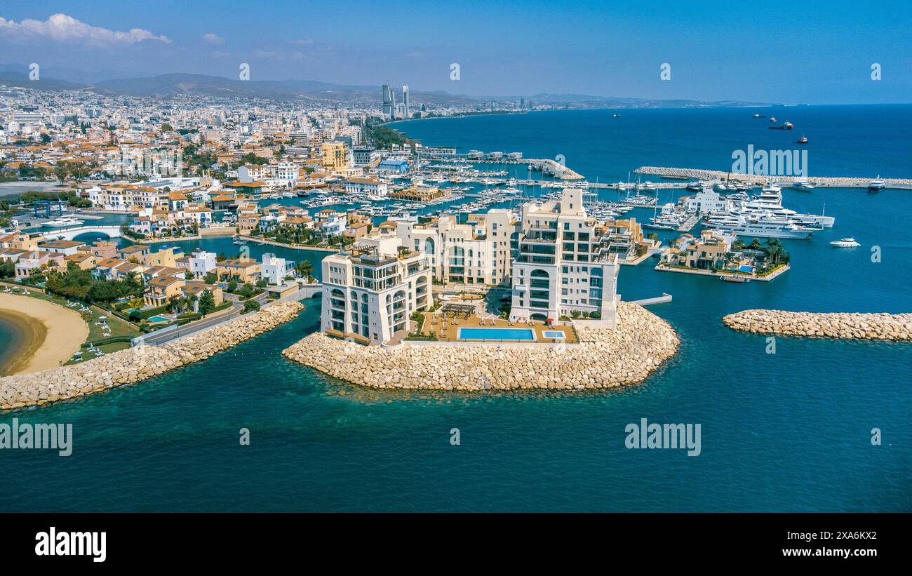 Aerial view of boats docked in a harbor with city buildings and sky in ...