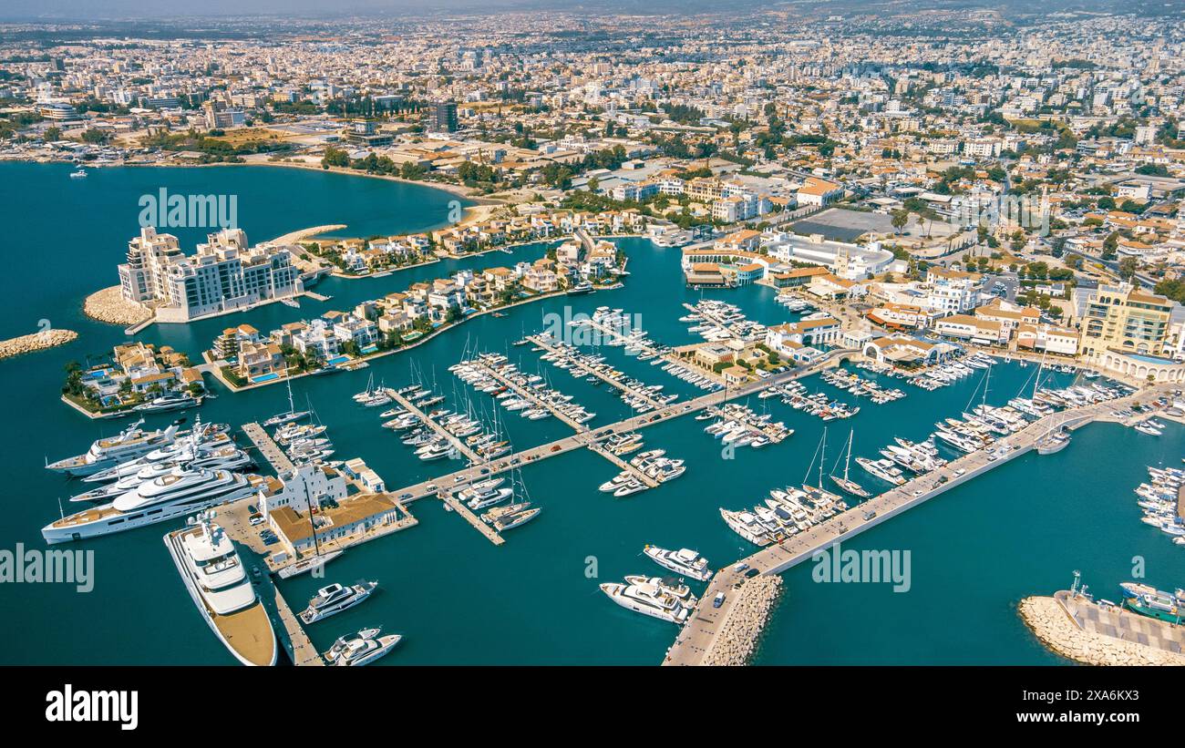 Aerial view of boats docked in a harbor with city buildings and sky in ...