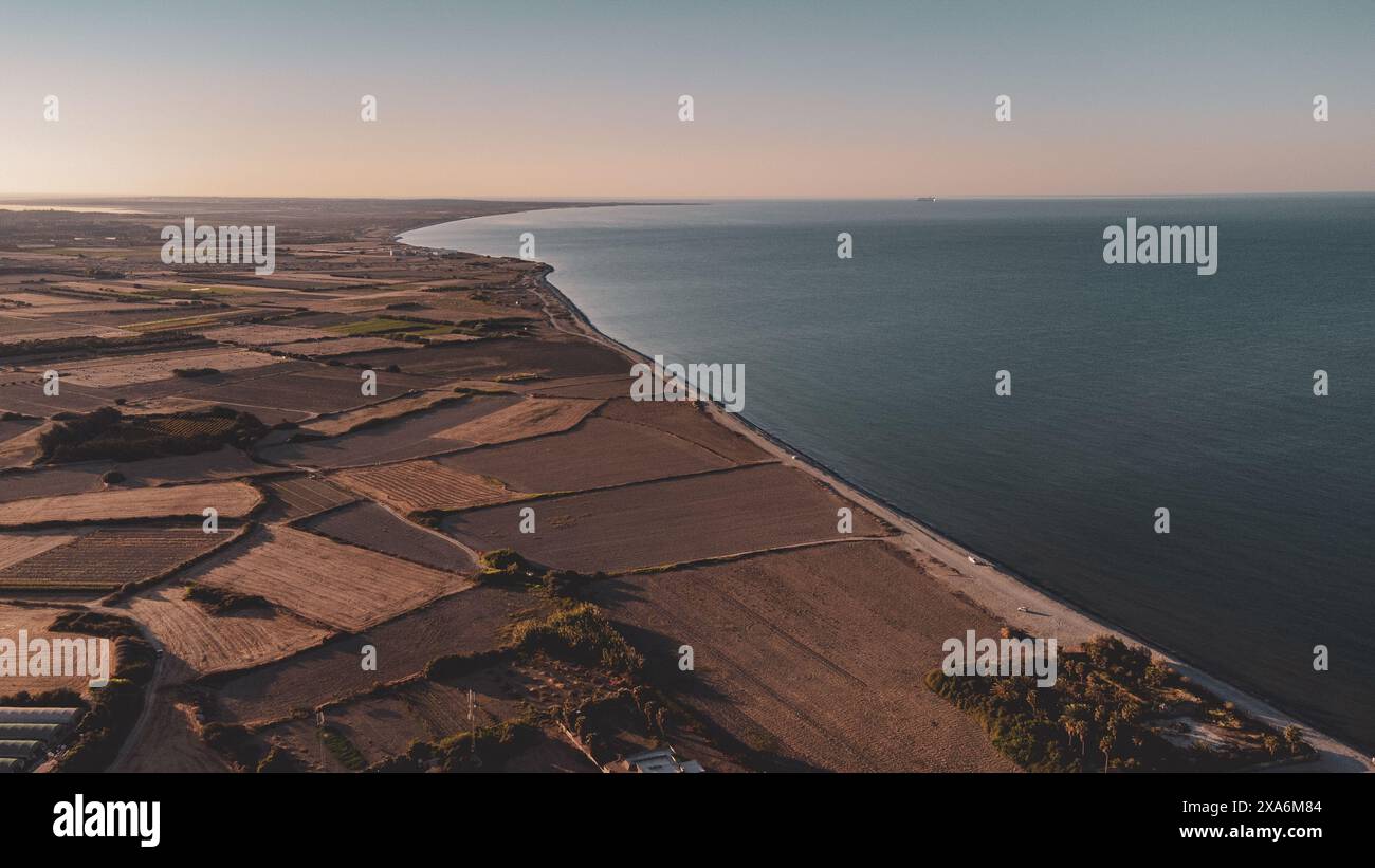 Aerial view of sunset over farm and dirt hills inKourion Amphitheater ...
