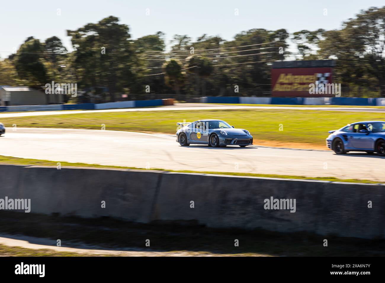 The two Porsche racing cars speeding on the Sebring track in the USA ...