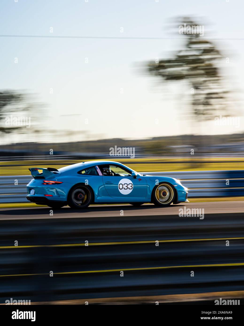 A blue Porsche racing on the track in Sebring, United States Stock ...