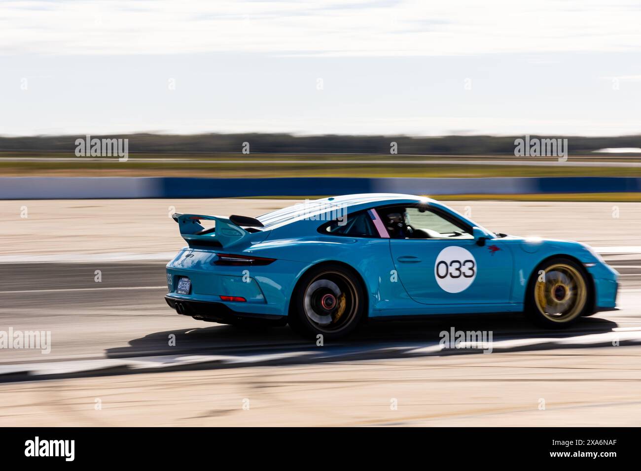 A blue Porsche racing on the track in Sebring, United States Stock ...