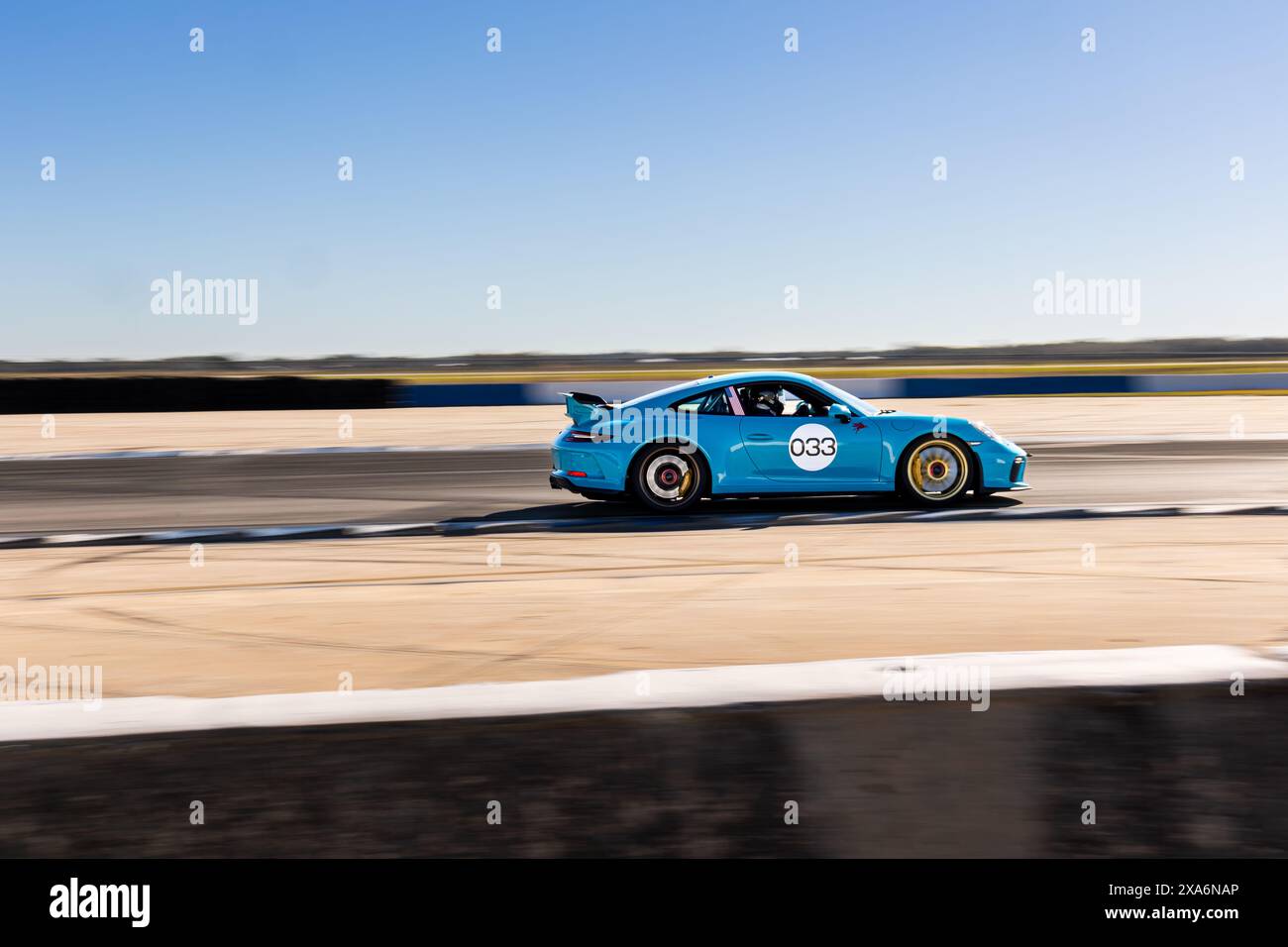 A blue Porsche racing on the track in Sebring, United States Stock ...