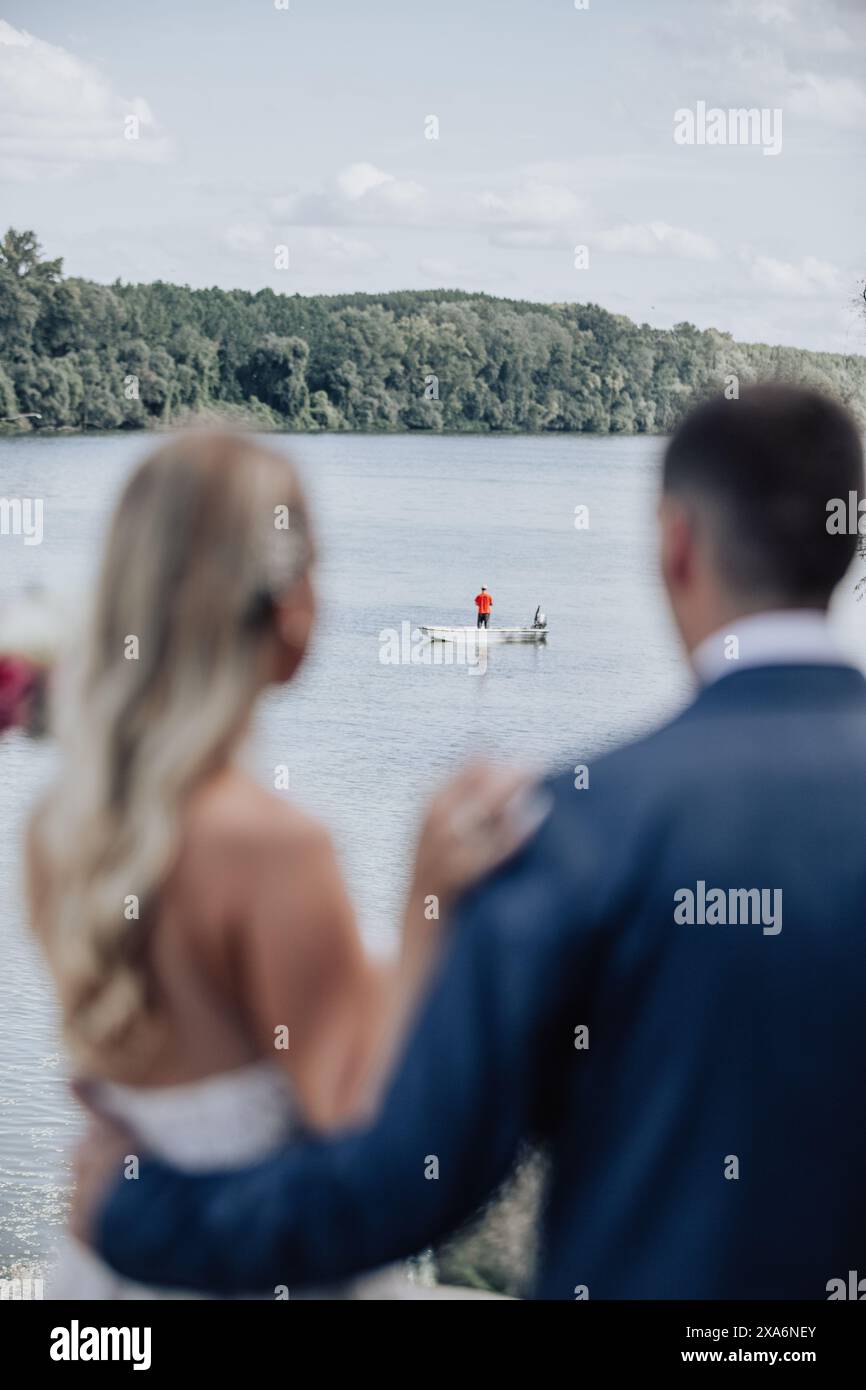The Bride and groom admire rowing boats on wedding day Stock Photo - Alamy