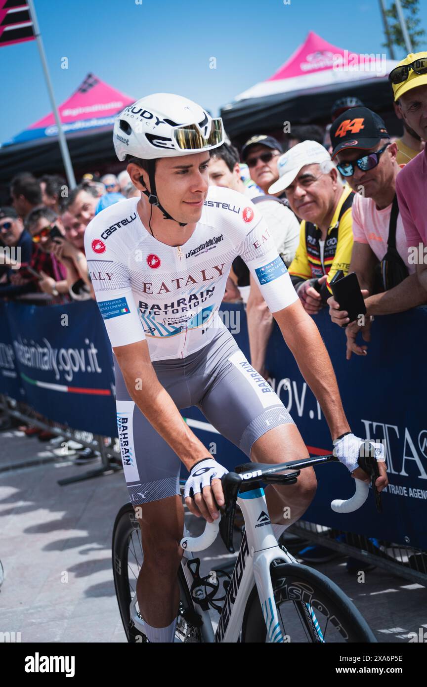 A cyclist riding a bike with spectators watching Stock Photo - Alamy
