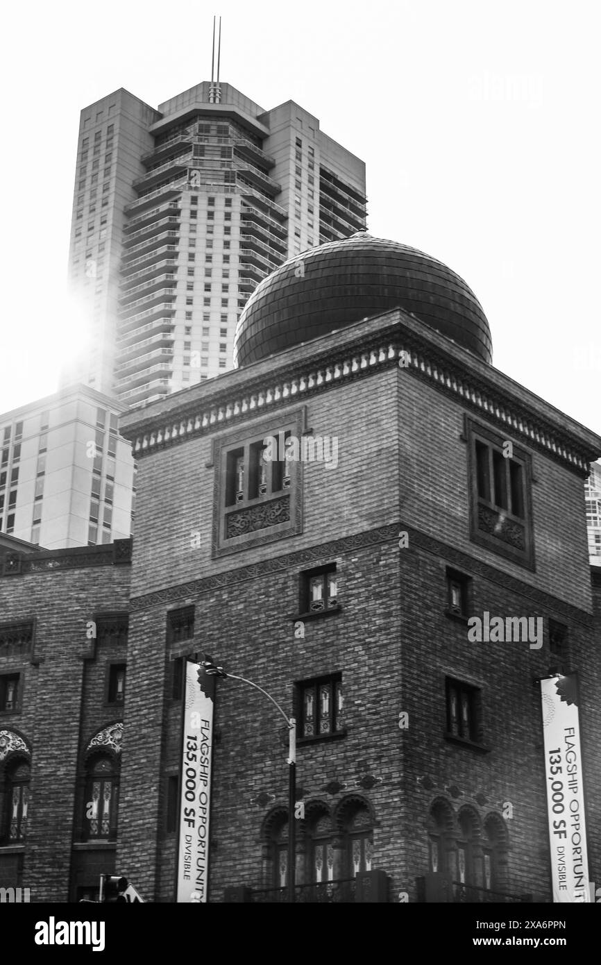 A dome-topped building with banners in front of other buildings in ...