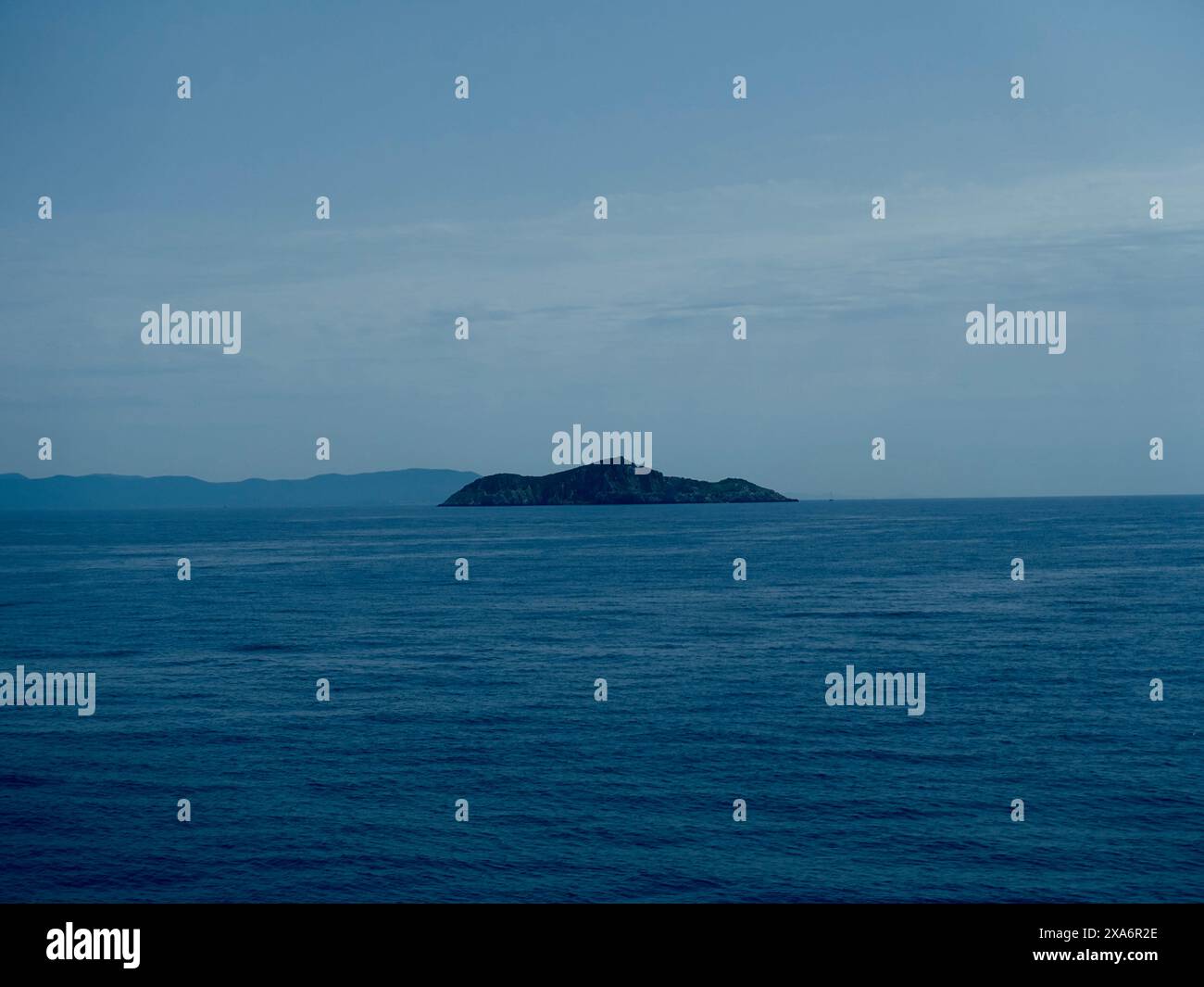 A scenic ocean view with a small island surrounded by blue water Stock ...