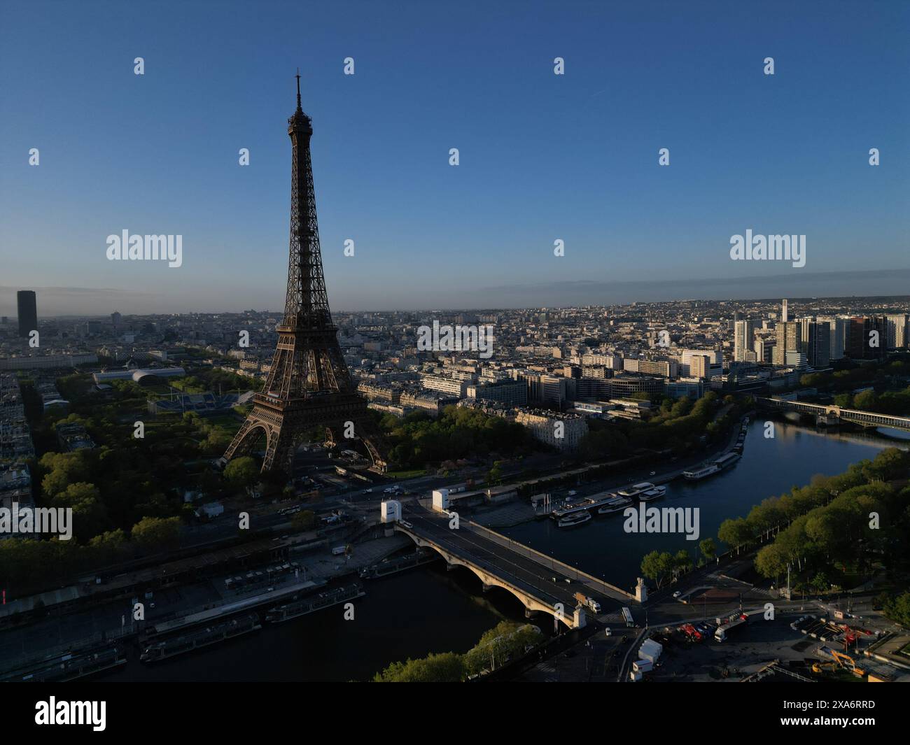 An aerial view of Eiffel Tower at sunrise, along with views of the ...