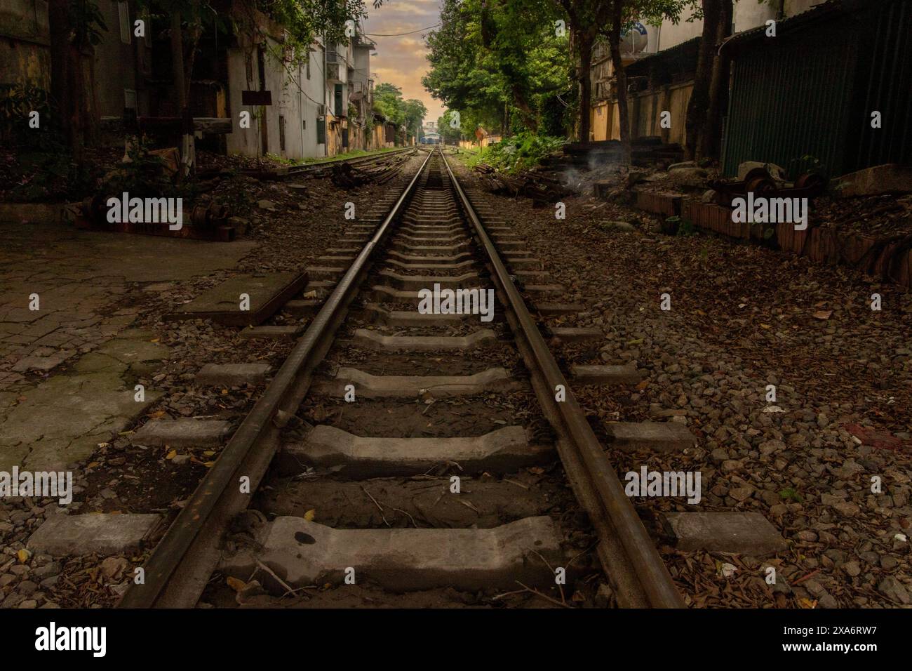 Rail track and blue Hanoi (Vietnam) 'Doorway Railway' train at rest ...