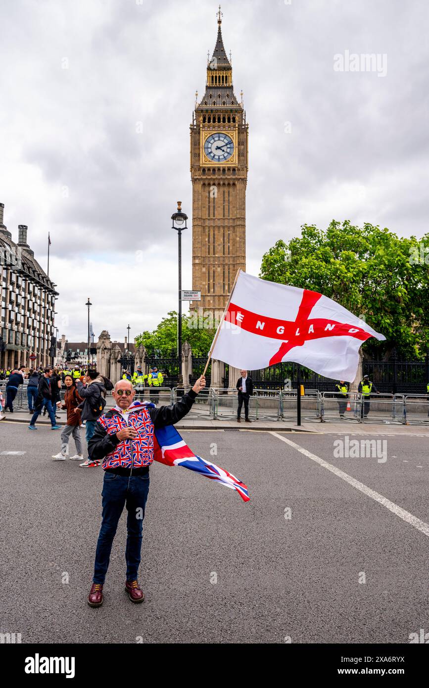 A Man Wearing a Union Jack Costume Waves An English Cross of St George ...