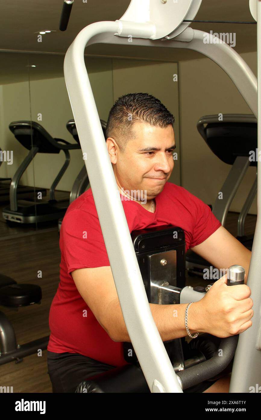 40-year-old dark-skinned Latino man does exercise to exercise his arm ...