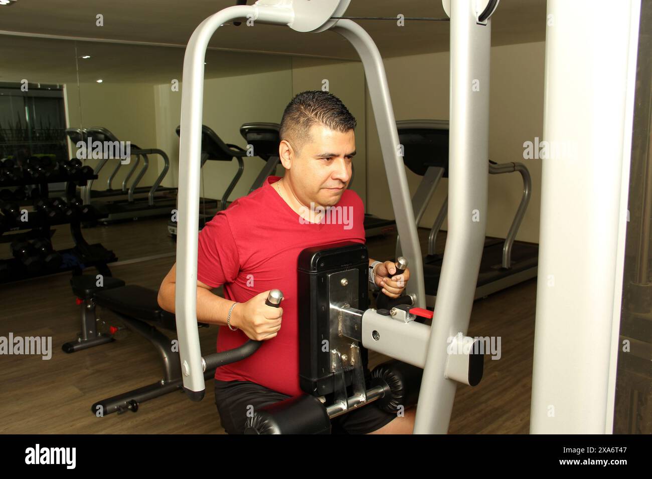 40-year-old dark-skinned Latino man does exercise to exercise his arm ...