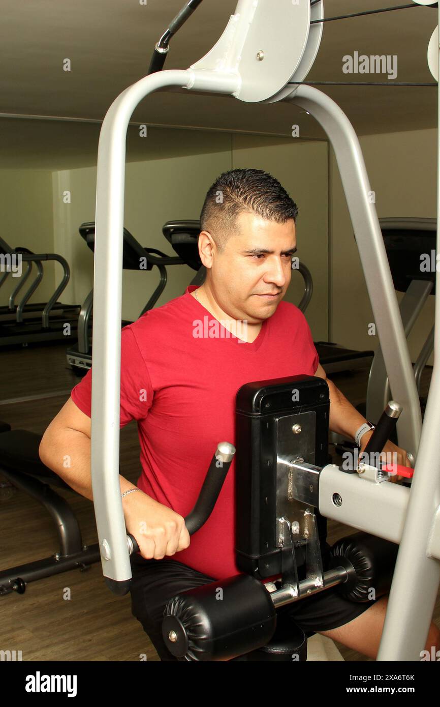 40-year-old dark-skinned Latino man does exercise to exercise his arm ...