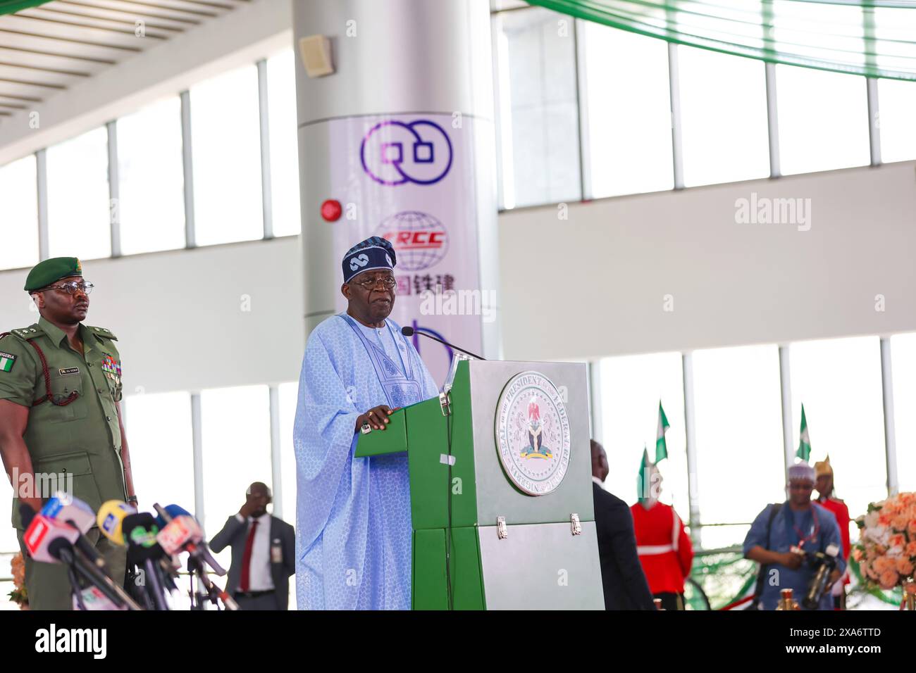 Abuja, Nigeria. 29th May, 2024. Nigerian President Bola Tinubu (C) speaks at the commercial ...