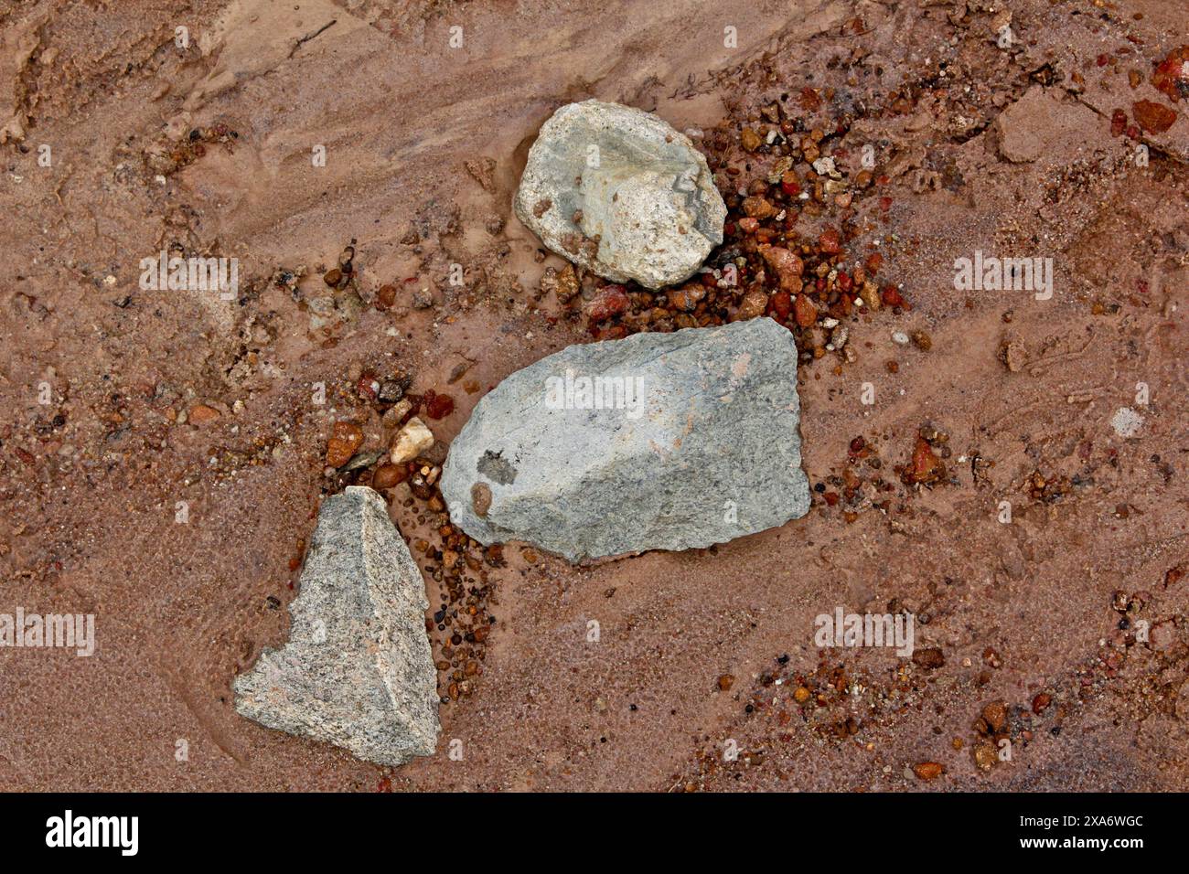 The Three rocks which are hand carved tools laying in the soil Stock ...