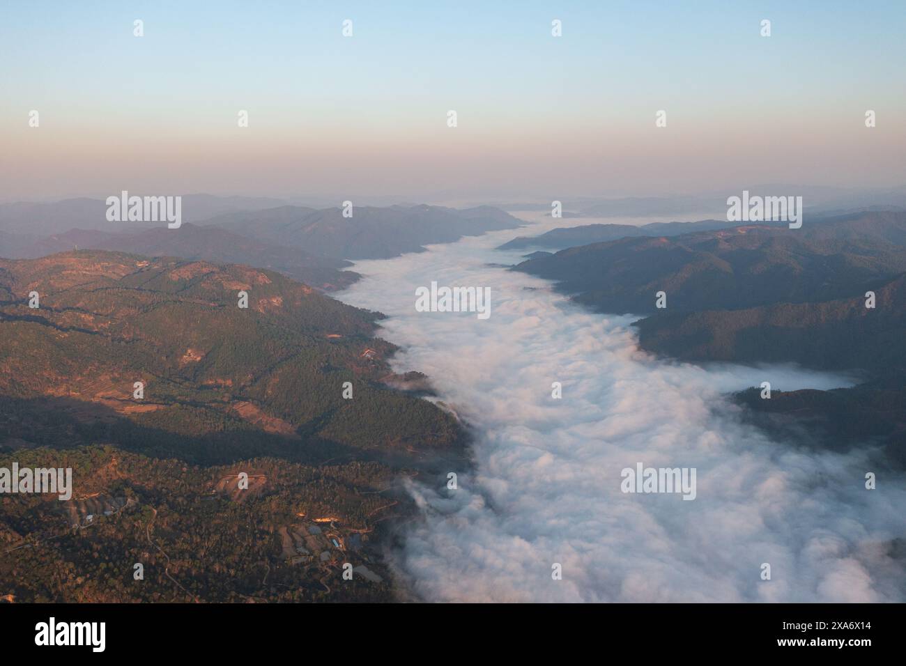 Thick clouds flowing into mountain tops from high above Stock Photo - Alamy