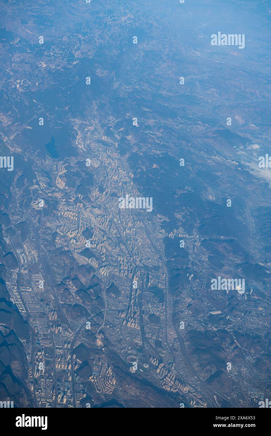 Aerial view of valley with buildings, mountains, and water Stock Photo ...