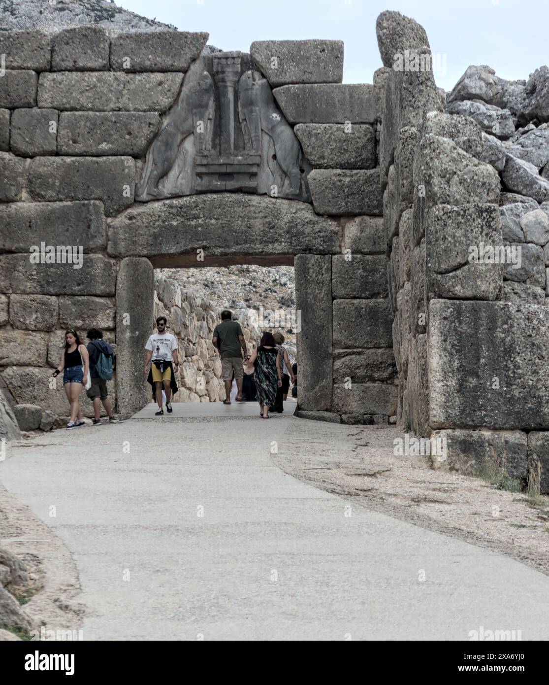 Tourists pass through Lions' Gate entrance at the famous ancient Greek ...