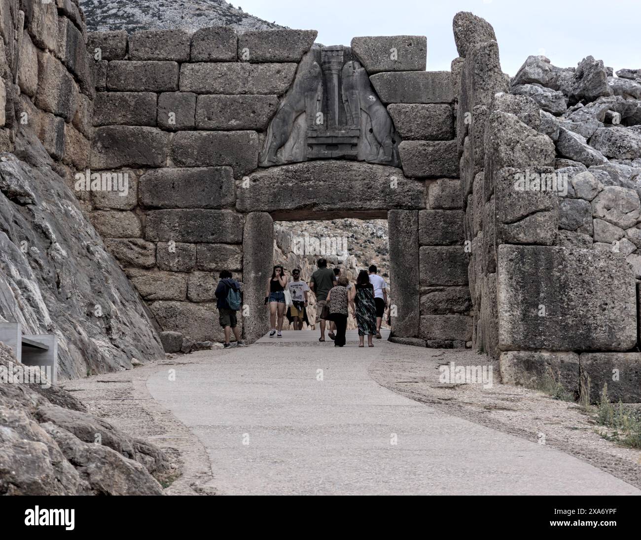 Tourists pass through Lions Gate entrance at the famous ancient Greek ...