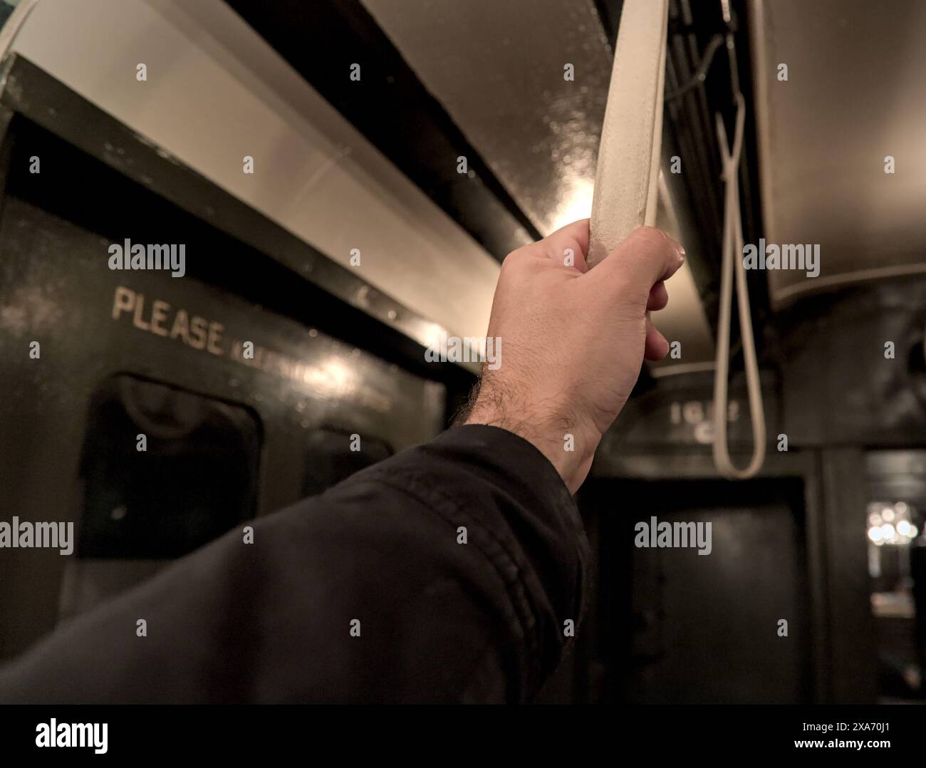 hand holding a strap on a subway car close up (vintage old time ...