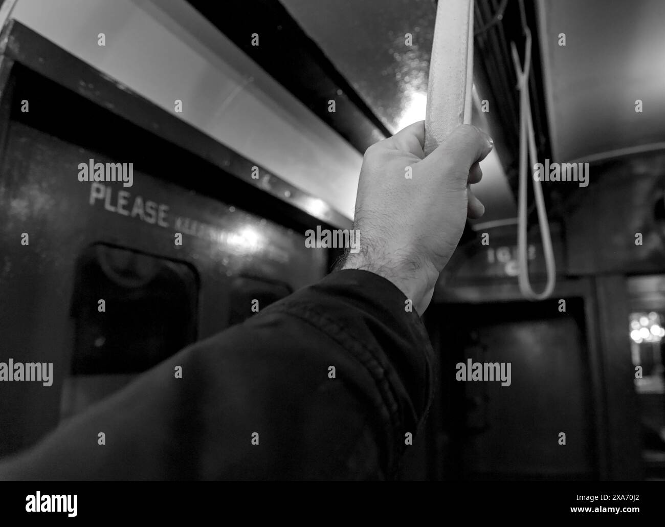 hand holding a strap on a subway car close up (vintage old time ...