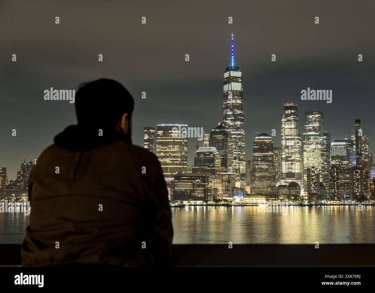 man looking at nyc skyline (from behind, silhouette) wearing hoodie and ...