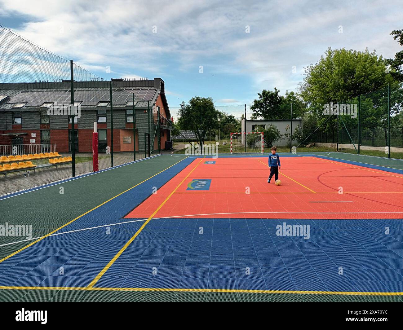A child playing on an outdoor basketball court Stock Photo - Alamy