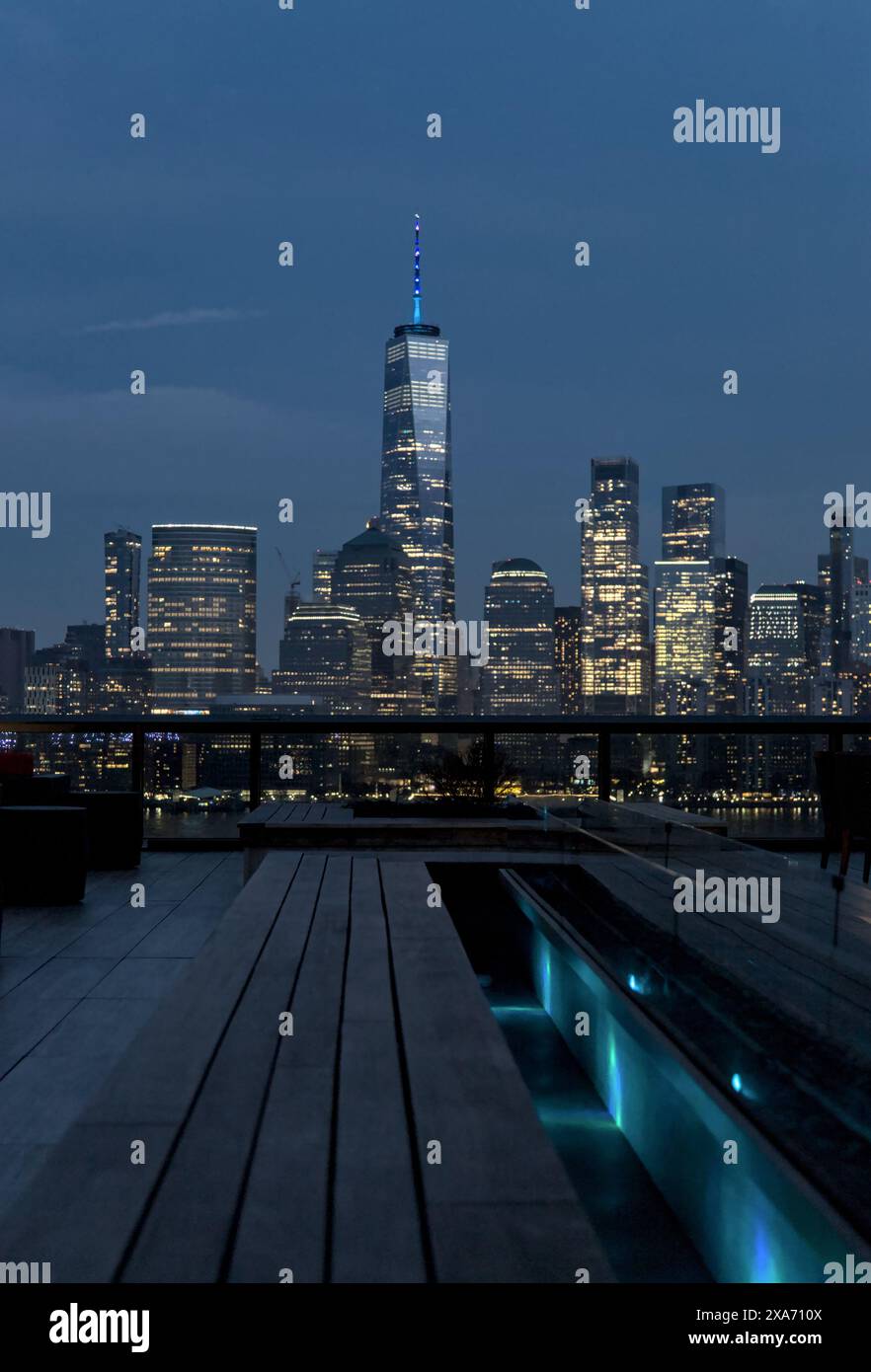 wooden bench on rooftop leading to view of downtown nyc (one world trade center freedom tower ...
