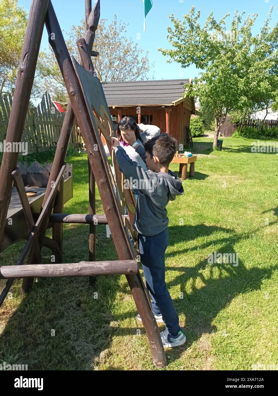 A child playing with a wooden structure Stock Photo - Alamy