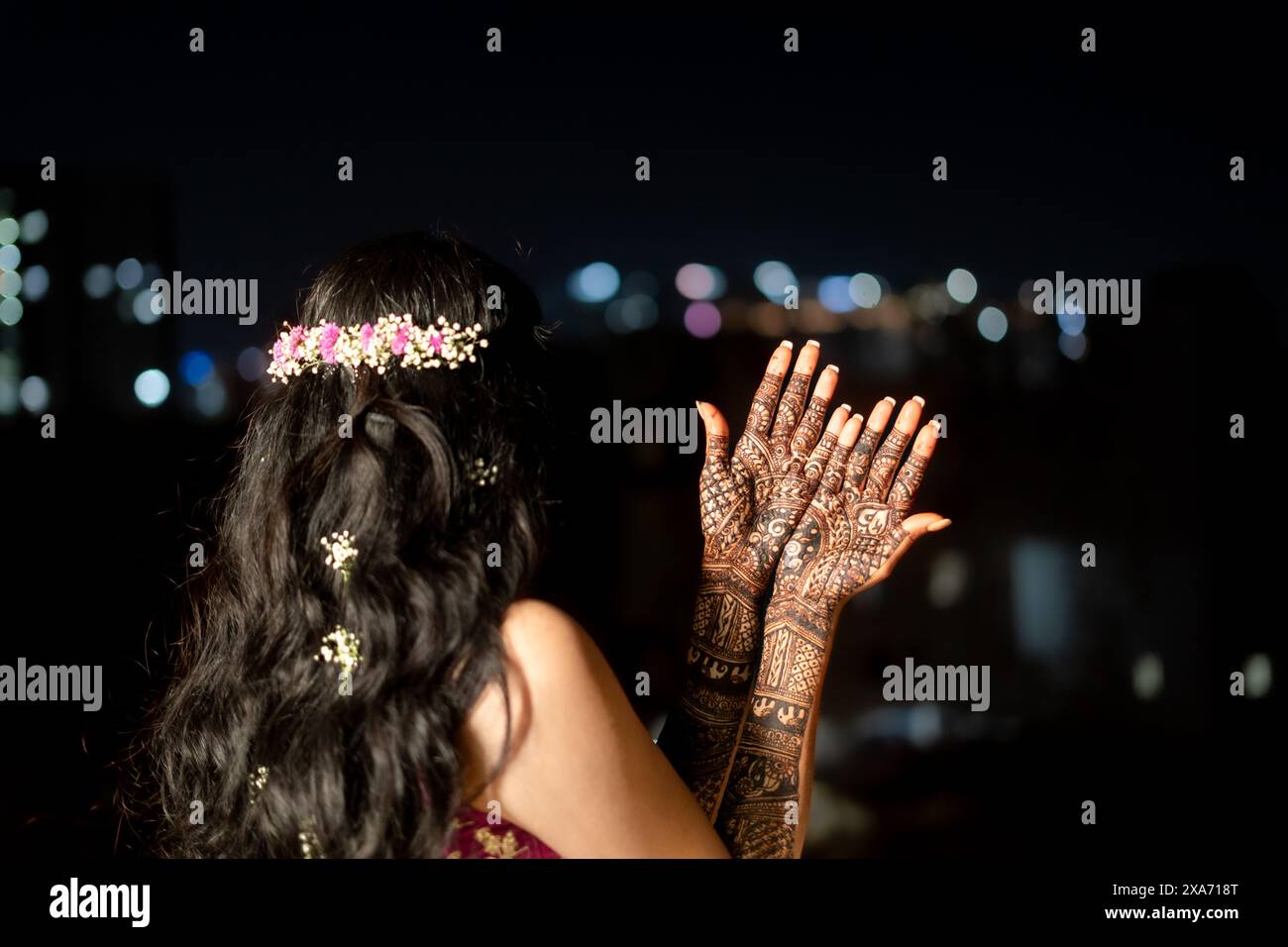 A woman raises her hands in the night Stock Photo - Alamy