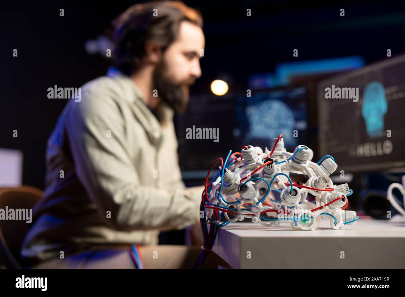 Focus on EEG headset used by engineer in blurry background to upload ...