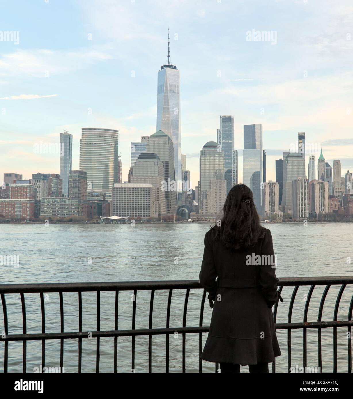 woman looking at downtown manhattan nyc skyline (after sunset, night ...