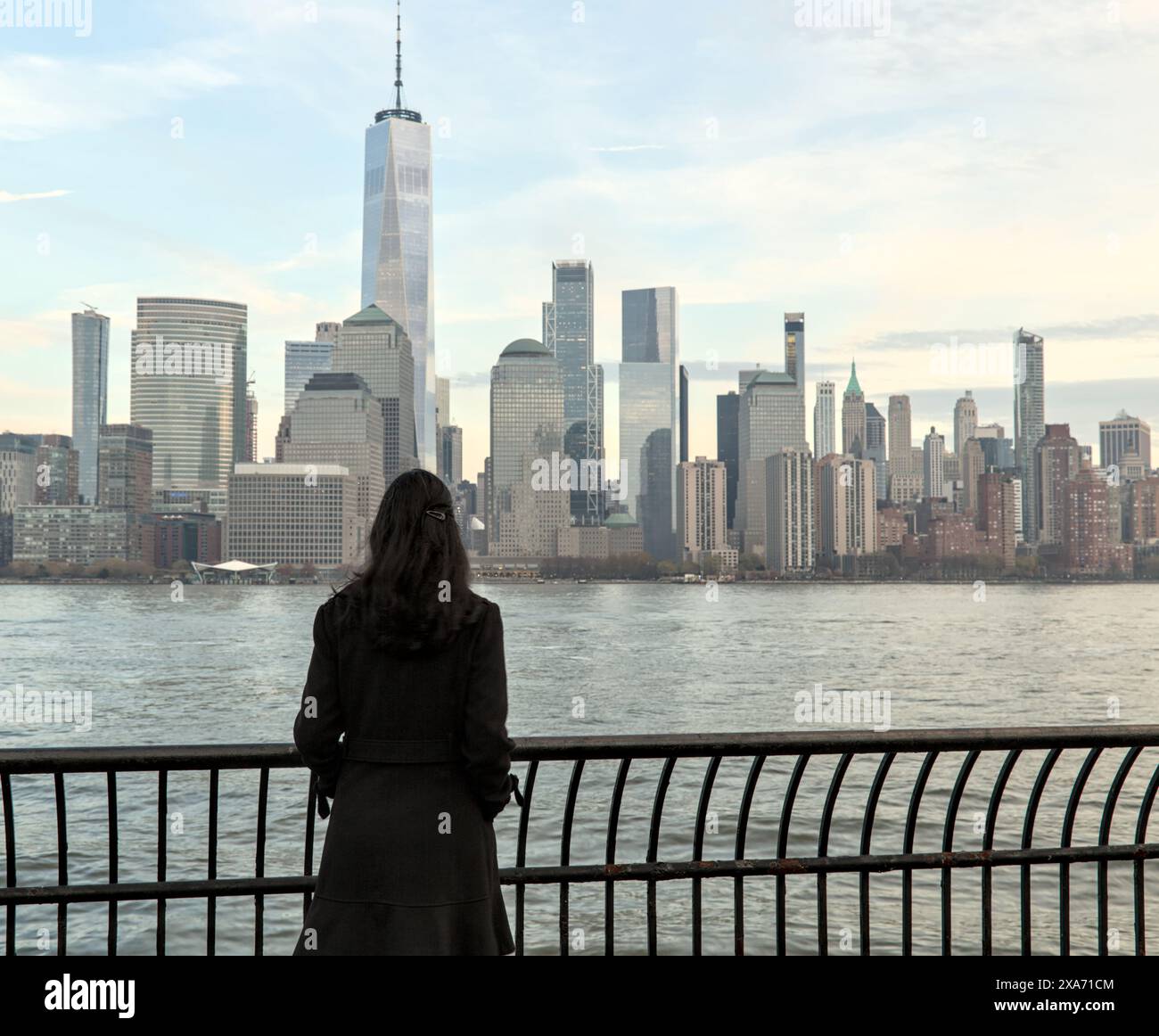 woman looking at downtown manhattan nyc skyline (after sunset, night ...