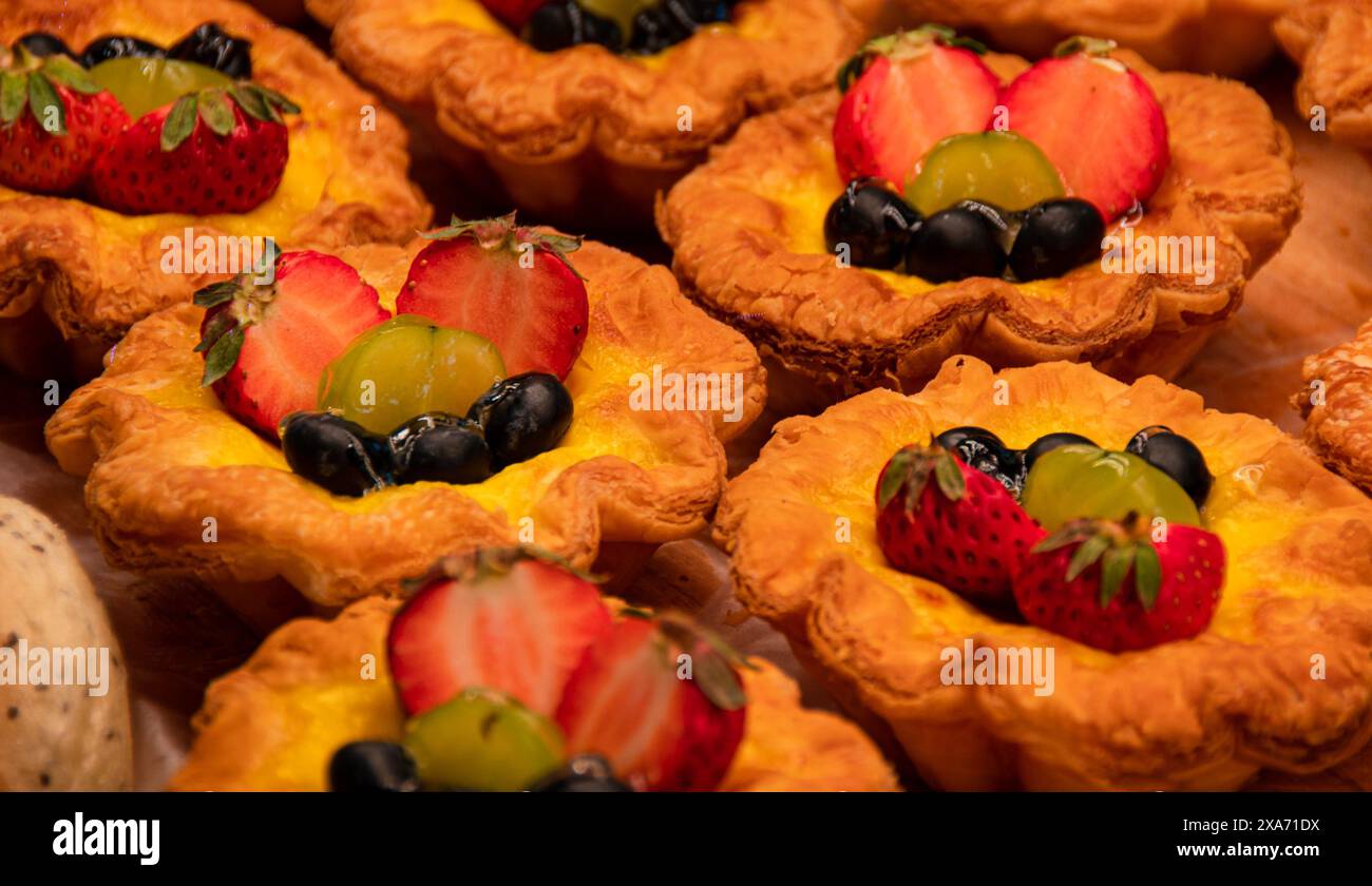 Rows of pastries topped with fresh fruit Stock Photo - Alamy