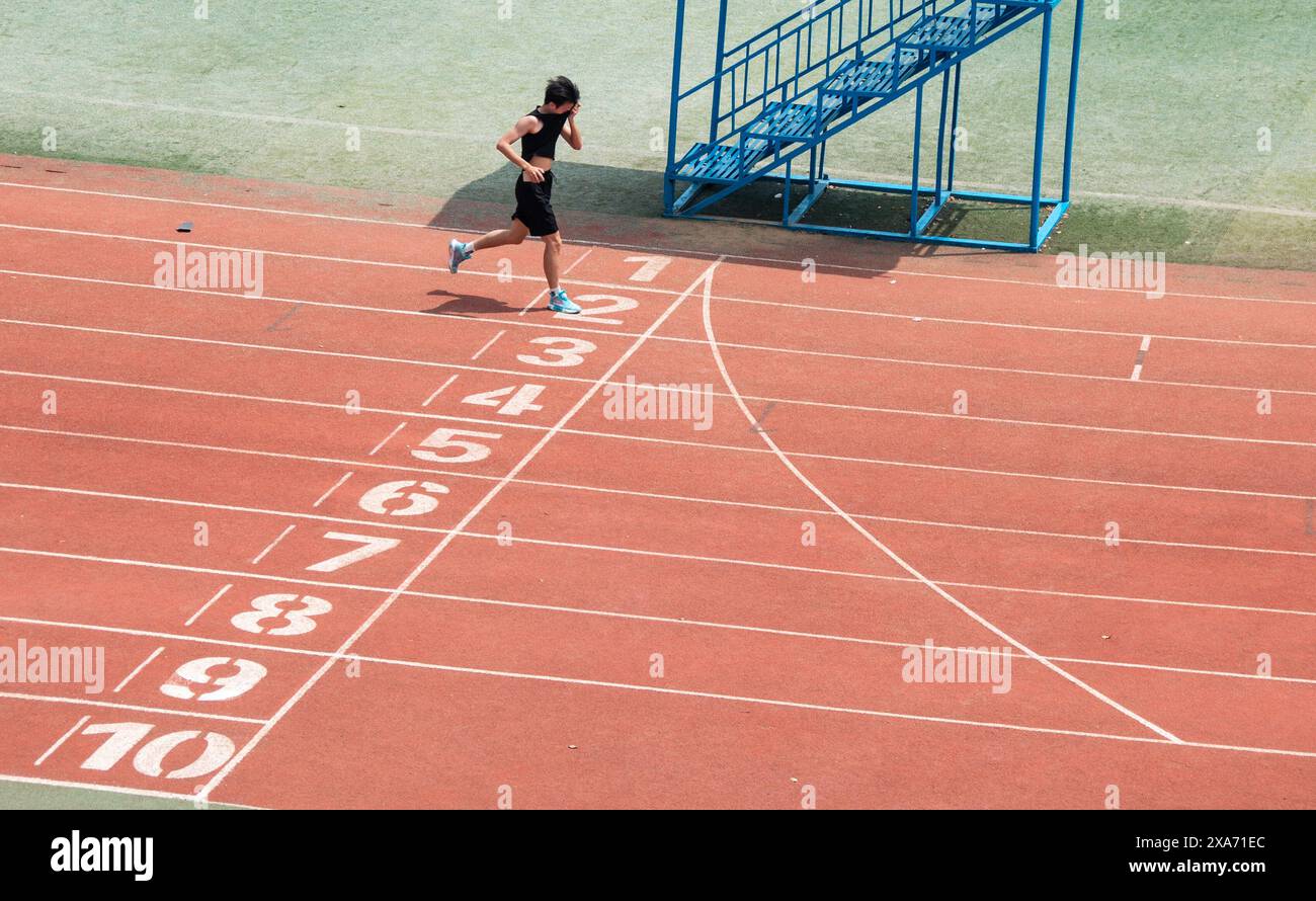 A young boy running on a colorful playground track for children Stock ...