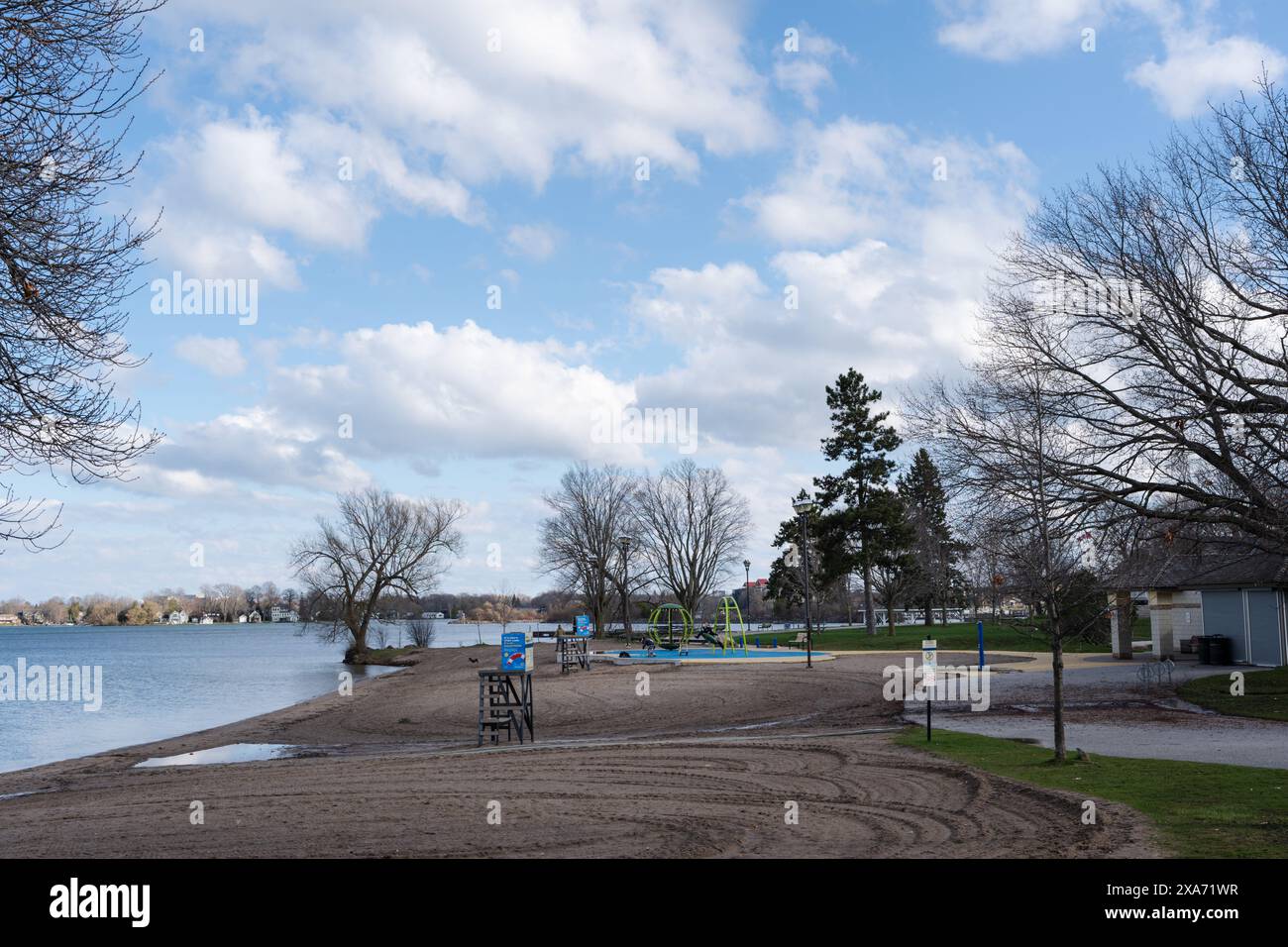 An empty beach during a sporting day of sun and clouds in Couchiching ...