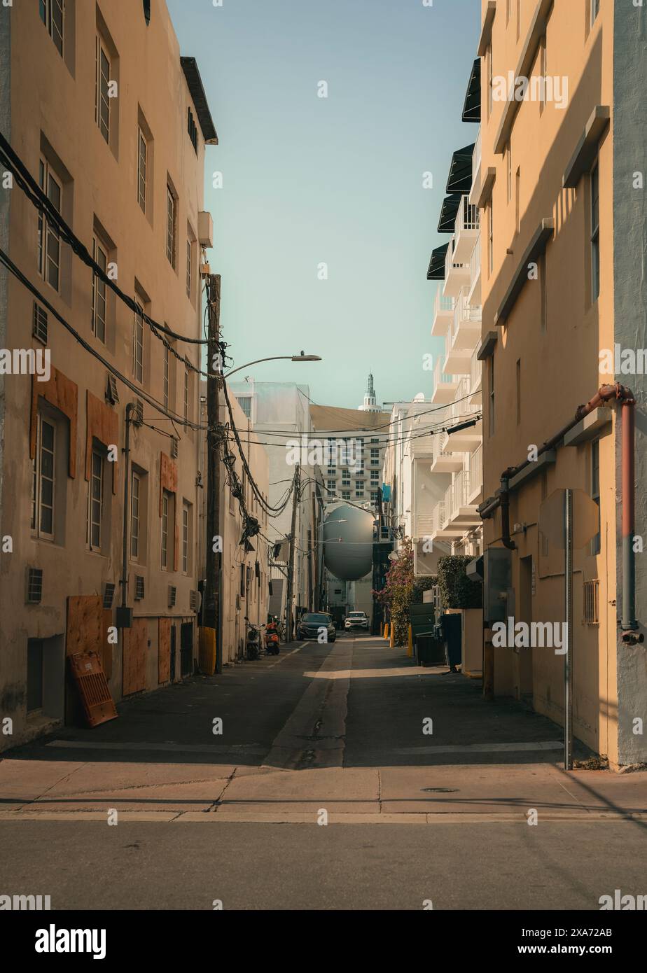 A city street view through buildings' alleyway Stock Photo - Alamy