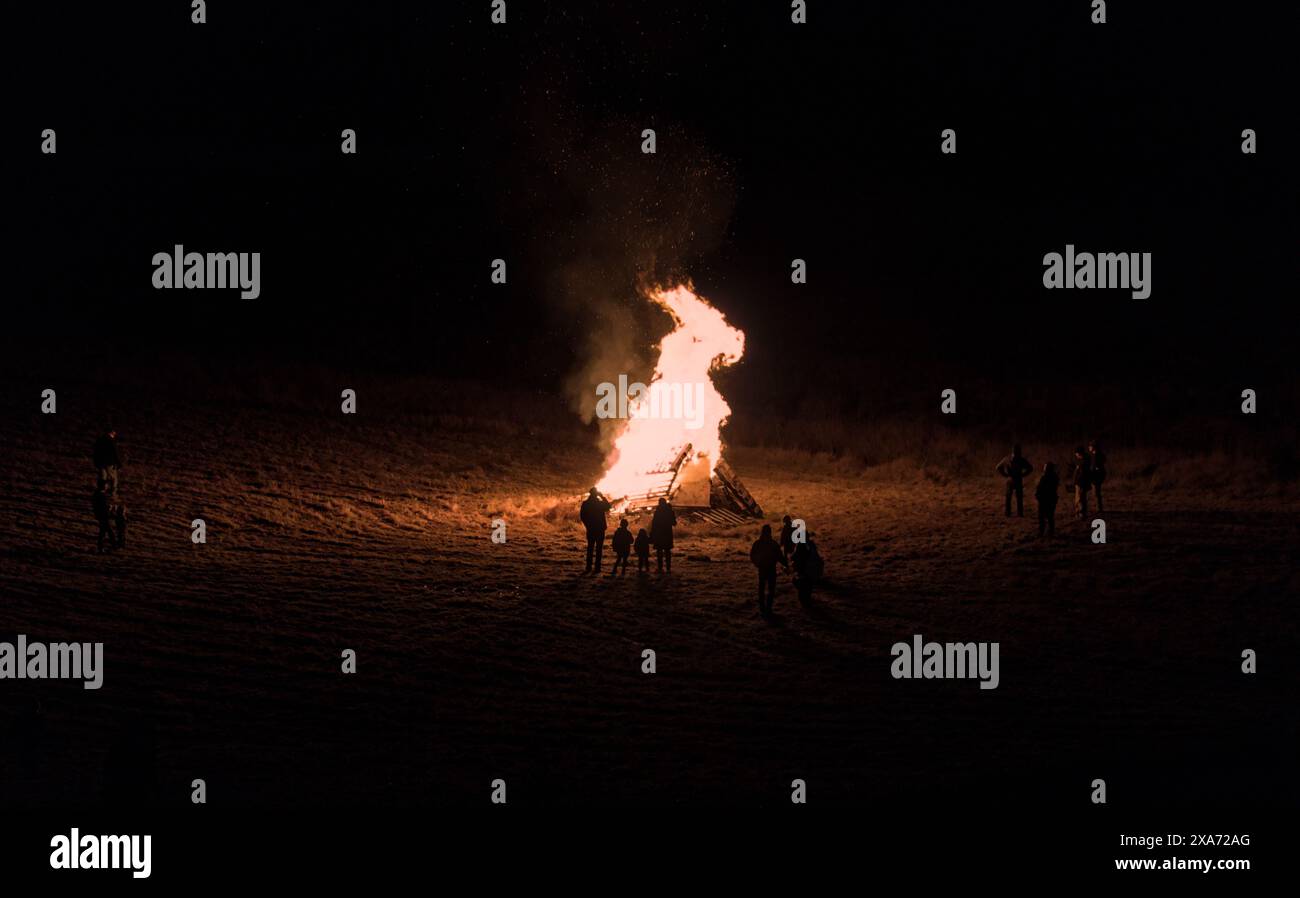 people gather around a bonfire in a rural field (winter warmth, family ...