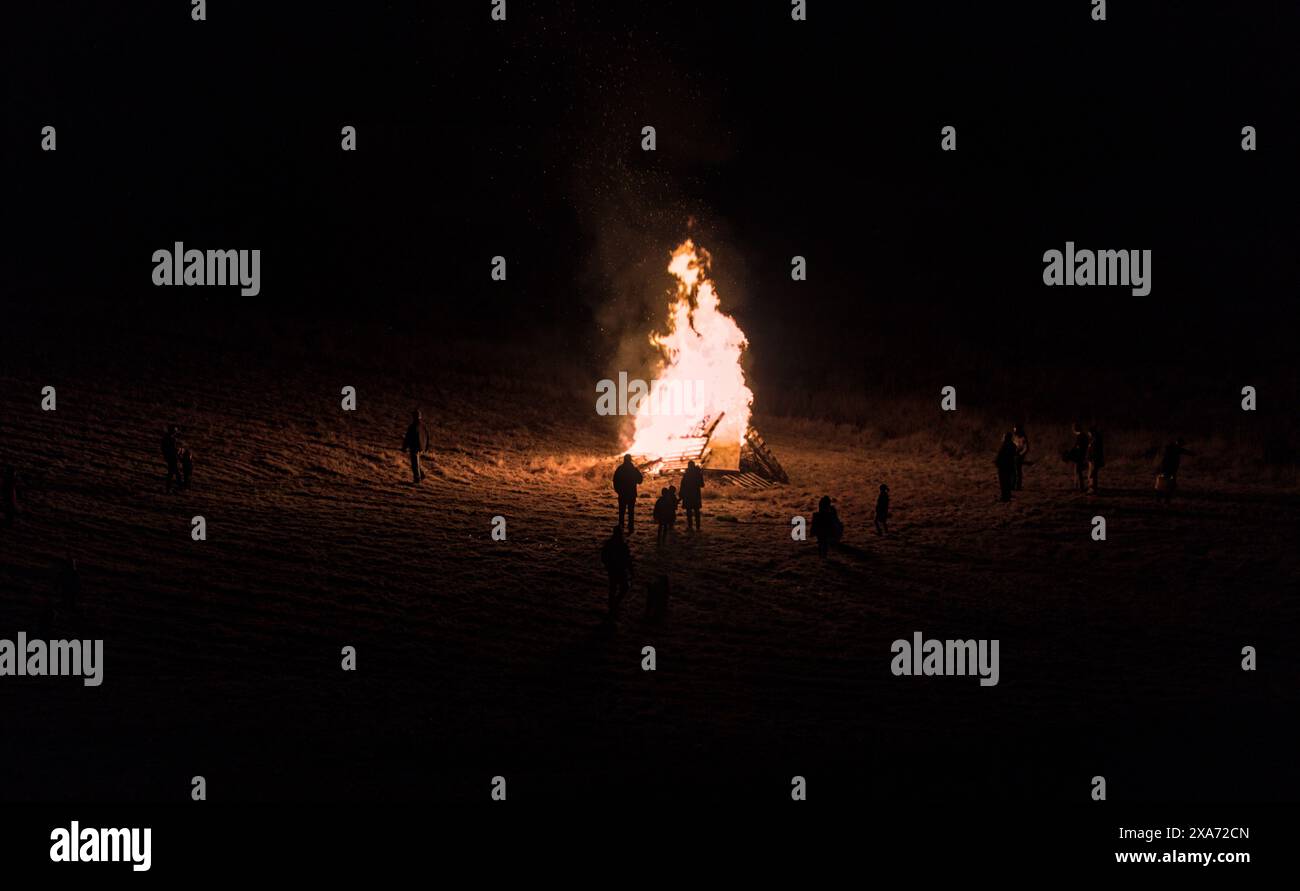people gather around a bonfire in a rural field (winter warmth, family ...
