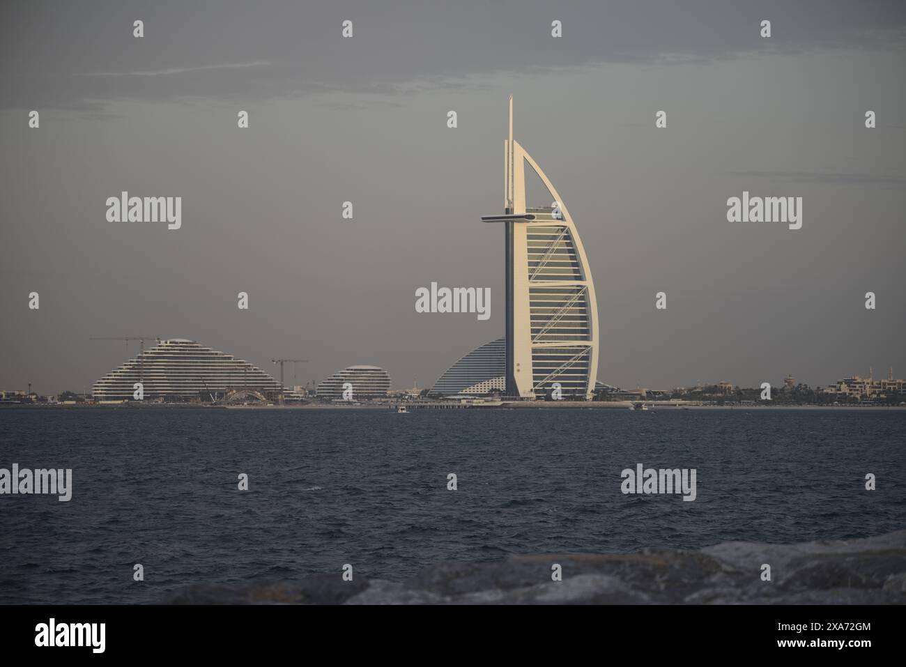 A distant building across the water, seen behind a boat Stock Photo - Alamy