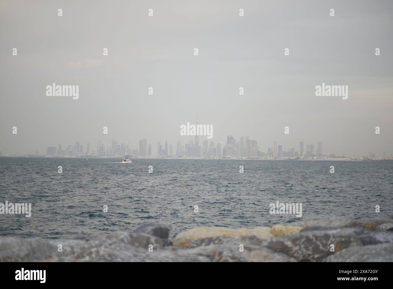 Ocean ripples with distant city skyscrapers Stock Photo - Alamy