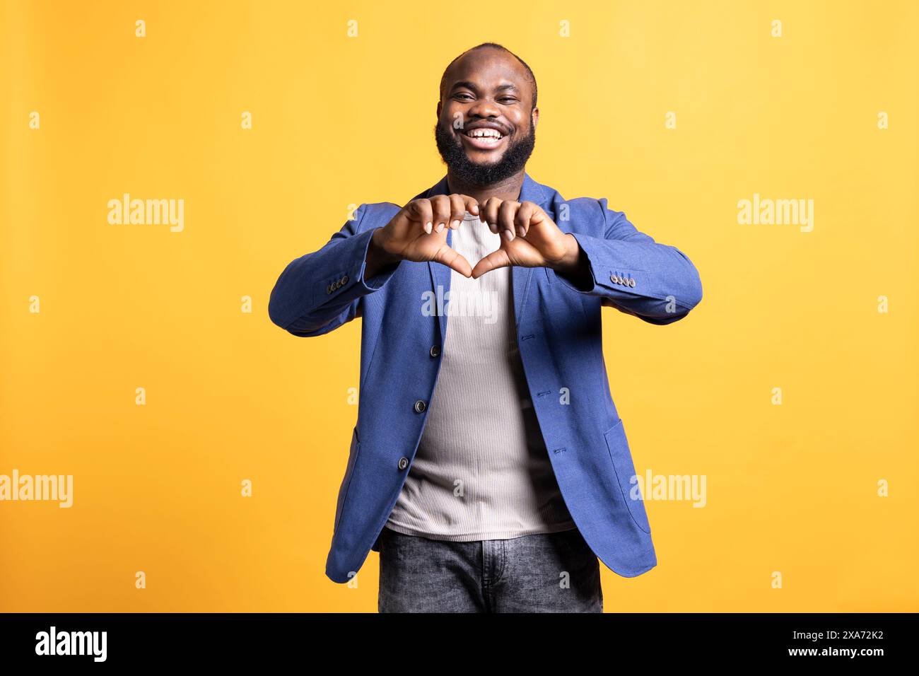 Portrait of loving joyous african american man doing heart symbol shape ...