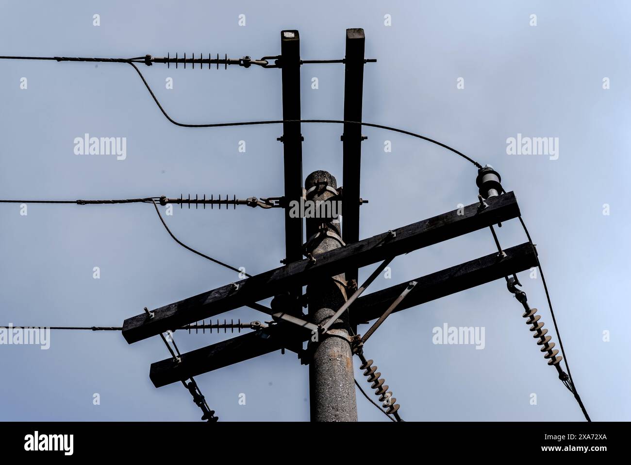 A small pole with three cables attached Stock Photo - Alamy
