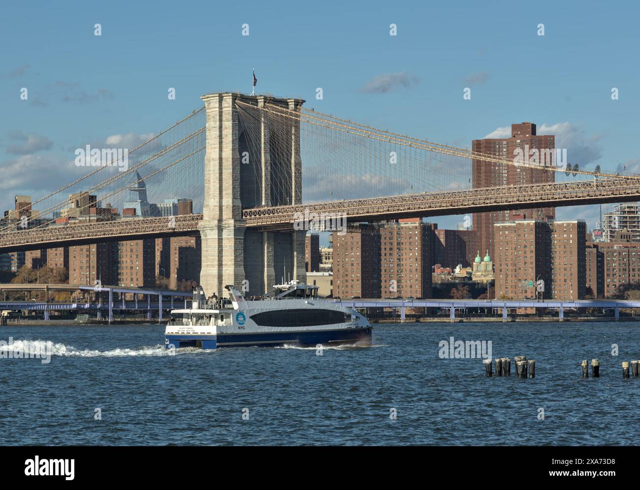 brooklyn bridge view over hudson river with nyc skyline background (urban cityscape of manhattan ...