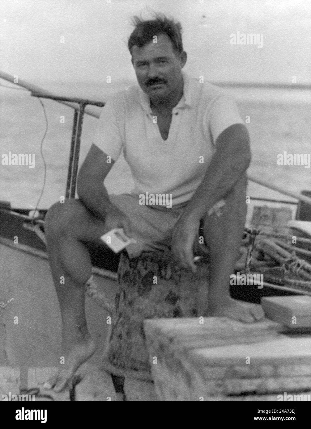 1930s Ernest Hemingway sitting on a dock next to the Pilar, 1930s ...
