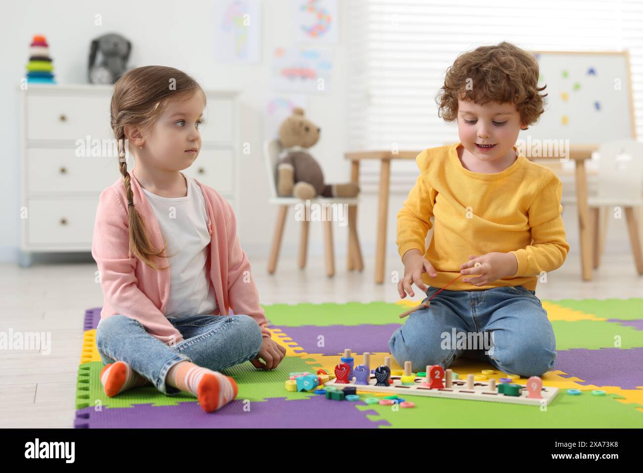 Cute little children playing with math game Fishing for Numbers on ...