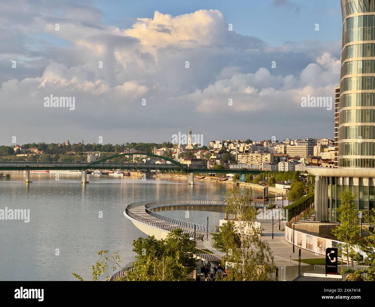 River flows past a massive building with people on it Stock Photo - Alamy