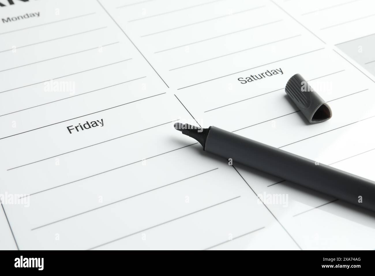 Timetable. Weekly planner and black felt pen, closeup Stock Photo - Alamy